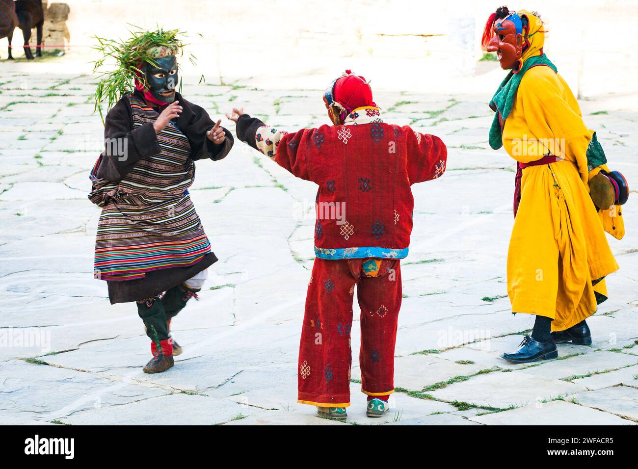 Three dancing monks disguised with masks to symbolize dieties and ...