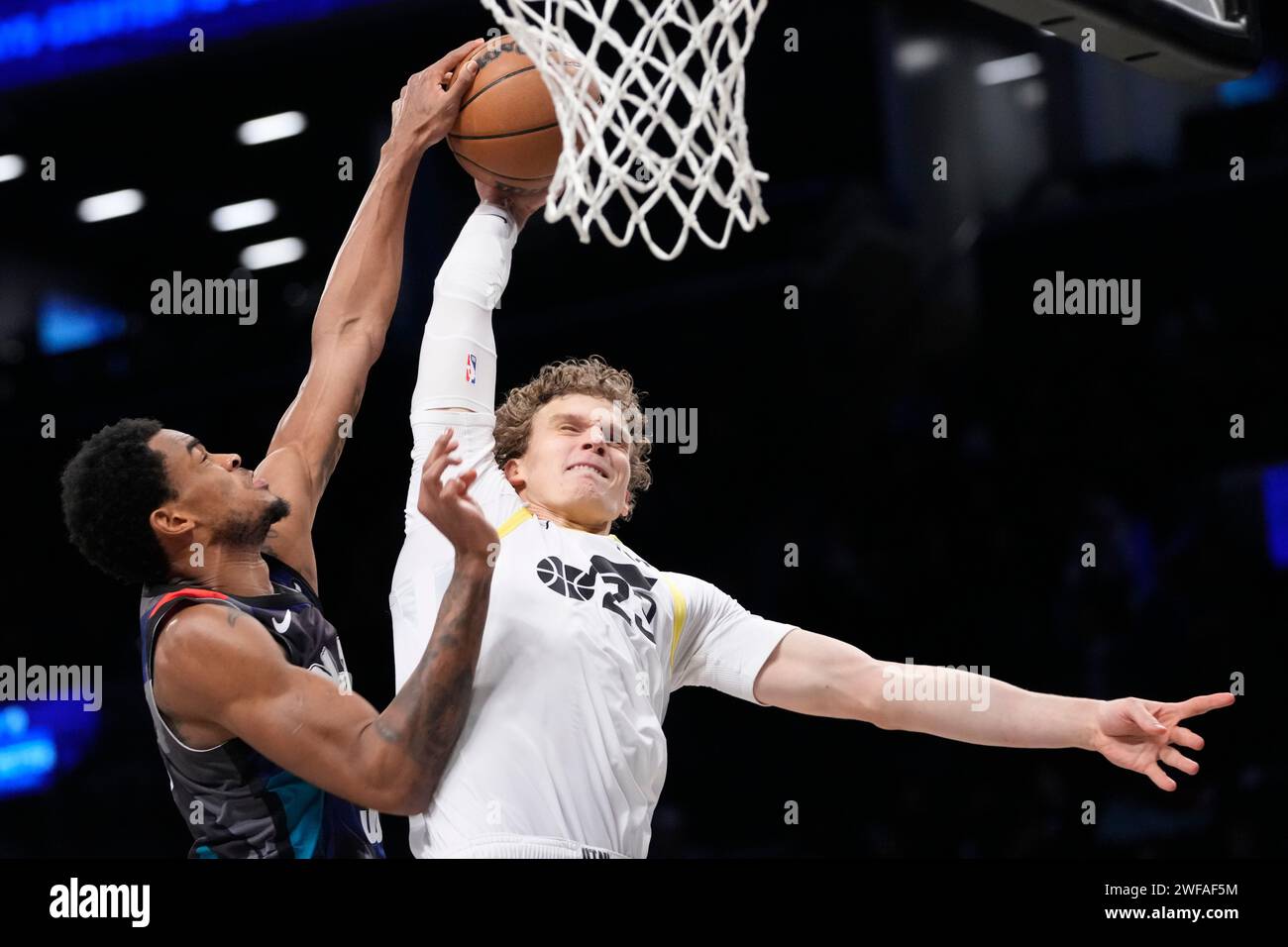 Brooklyn Nets center Nic Claxton, left, stops Utah Jazz forward Lauri Markkanen (23) from ...