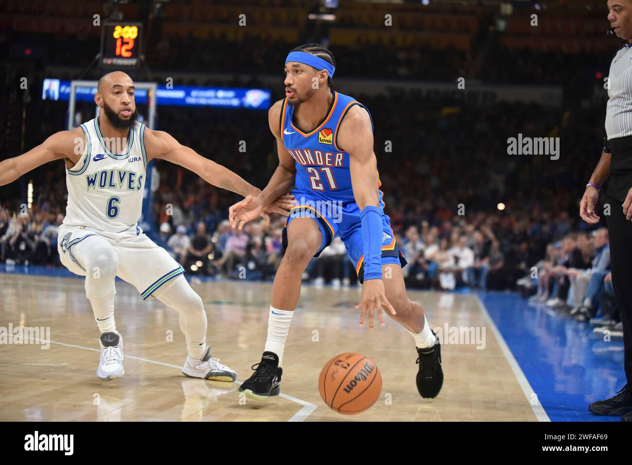 Oklahoma City Thunder guard Aaron Wiggins (21) drives past Minnesota Timberwolves guard Jordan ...