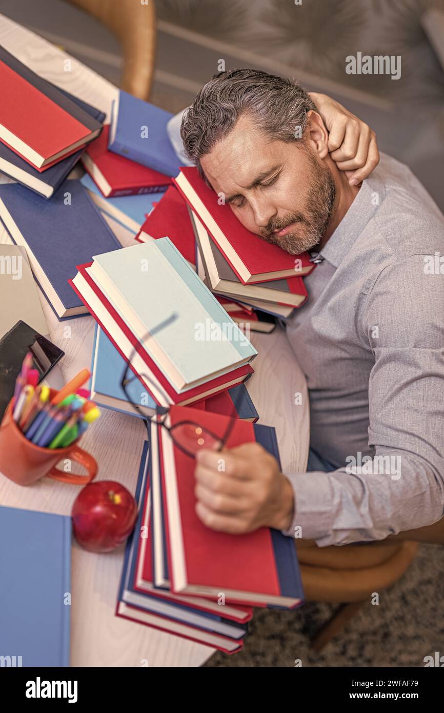 overworked school teacher professor prepare for exam reading books ...