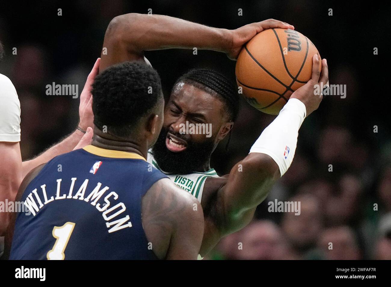 Boston Celtics guard Jaylen Brown, right, grabs a rebound in front of ...