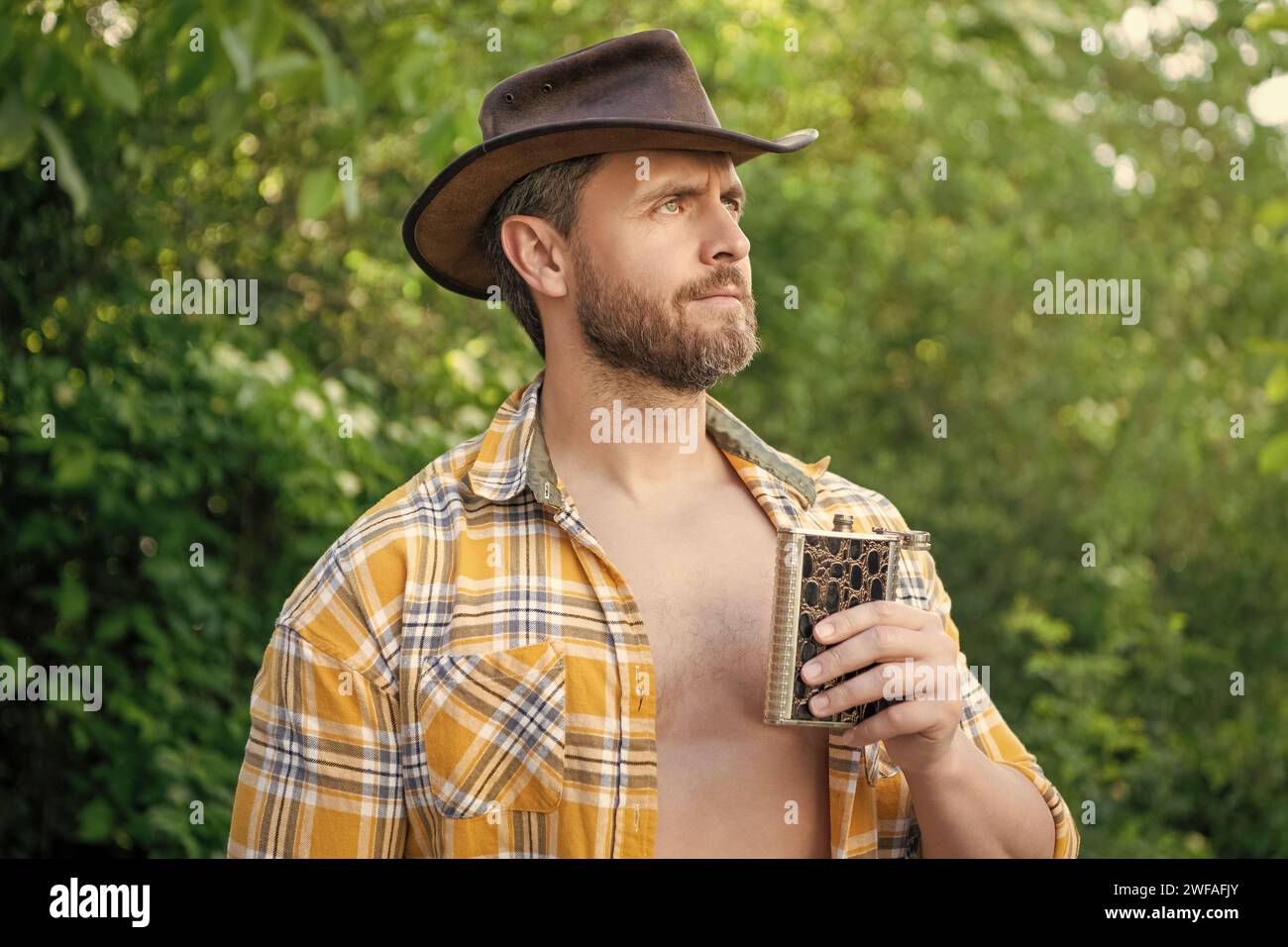 masculine cowboy thinking with flask. masculine cowboy with flask ...