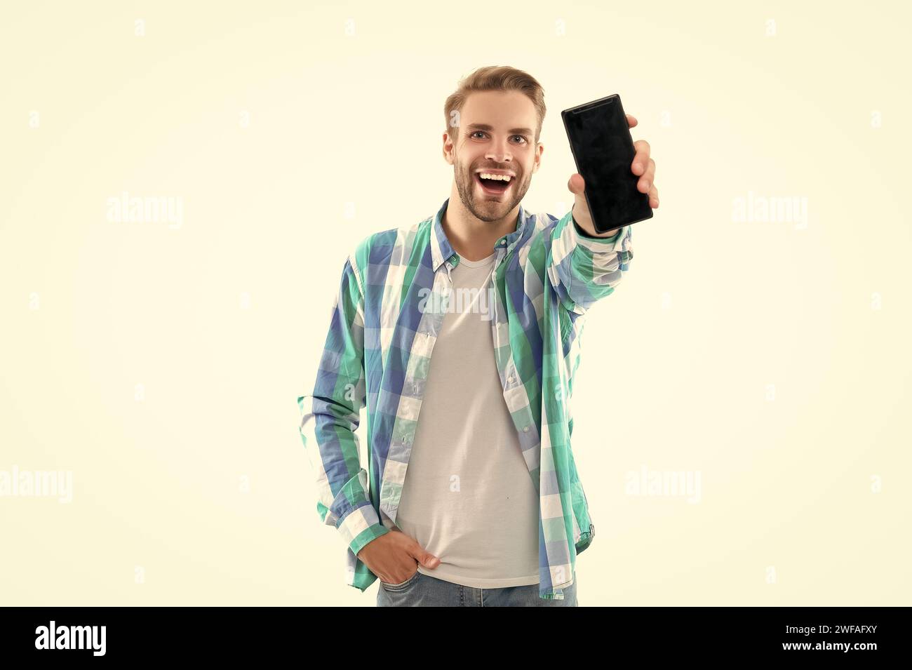happy man with phone screen isolated on white. man shows phone screen ...