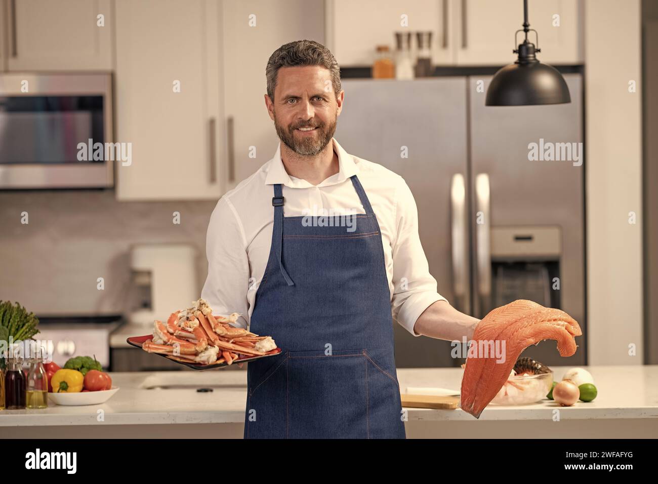 image of chef with lobster and salmon seafood. chef with lobster and ...