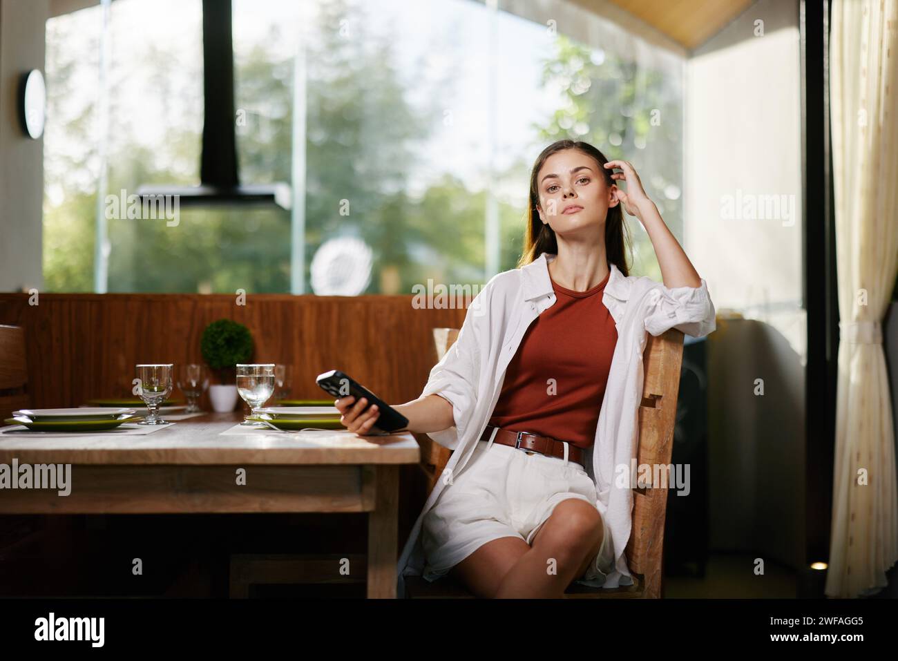 Lifestyle sitting caucasian female casual cafe pretty attractive young ...