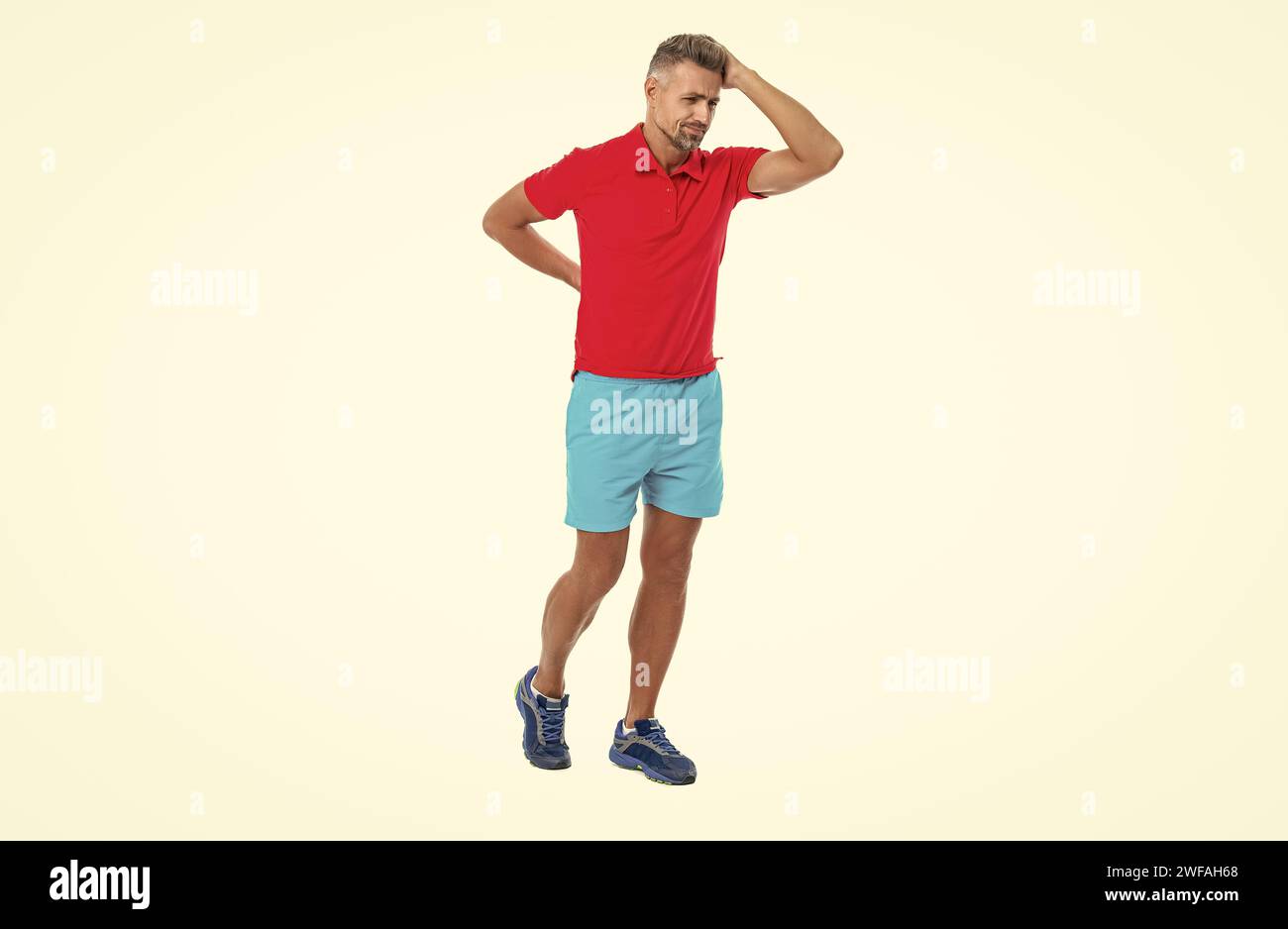 sport man massages his lower back to alleviate discomfort of backache ...