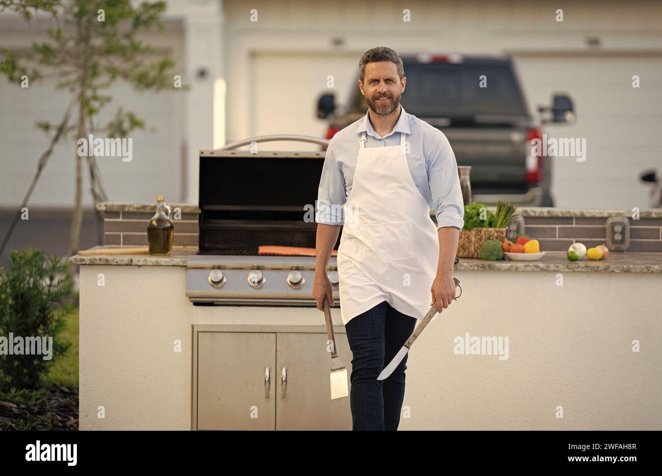 happy man grilling salmon fillet. man grilling salmon fillet outdoor ...