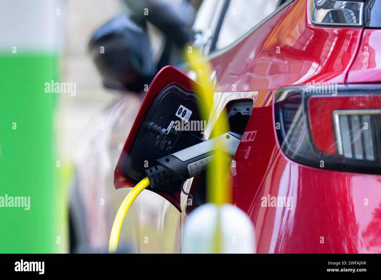 Electromobility, electric car, e-car, being charged at a charging ...