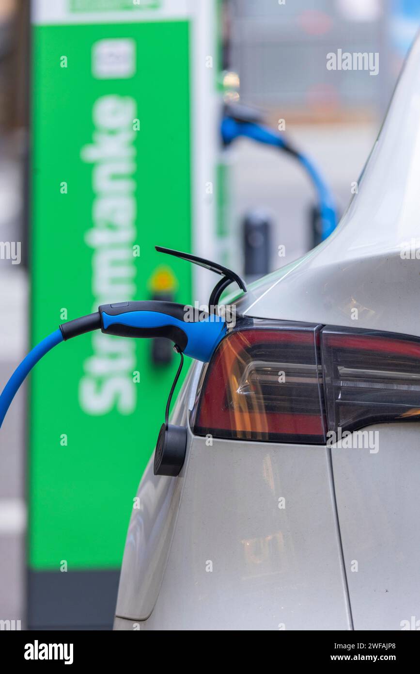 Electromobility, electric car, e-car, being charged at a charging ...