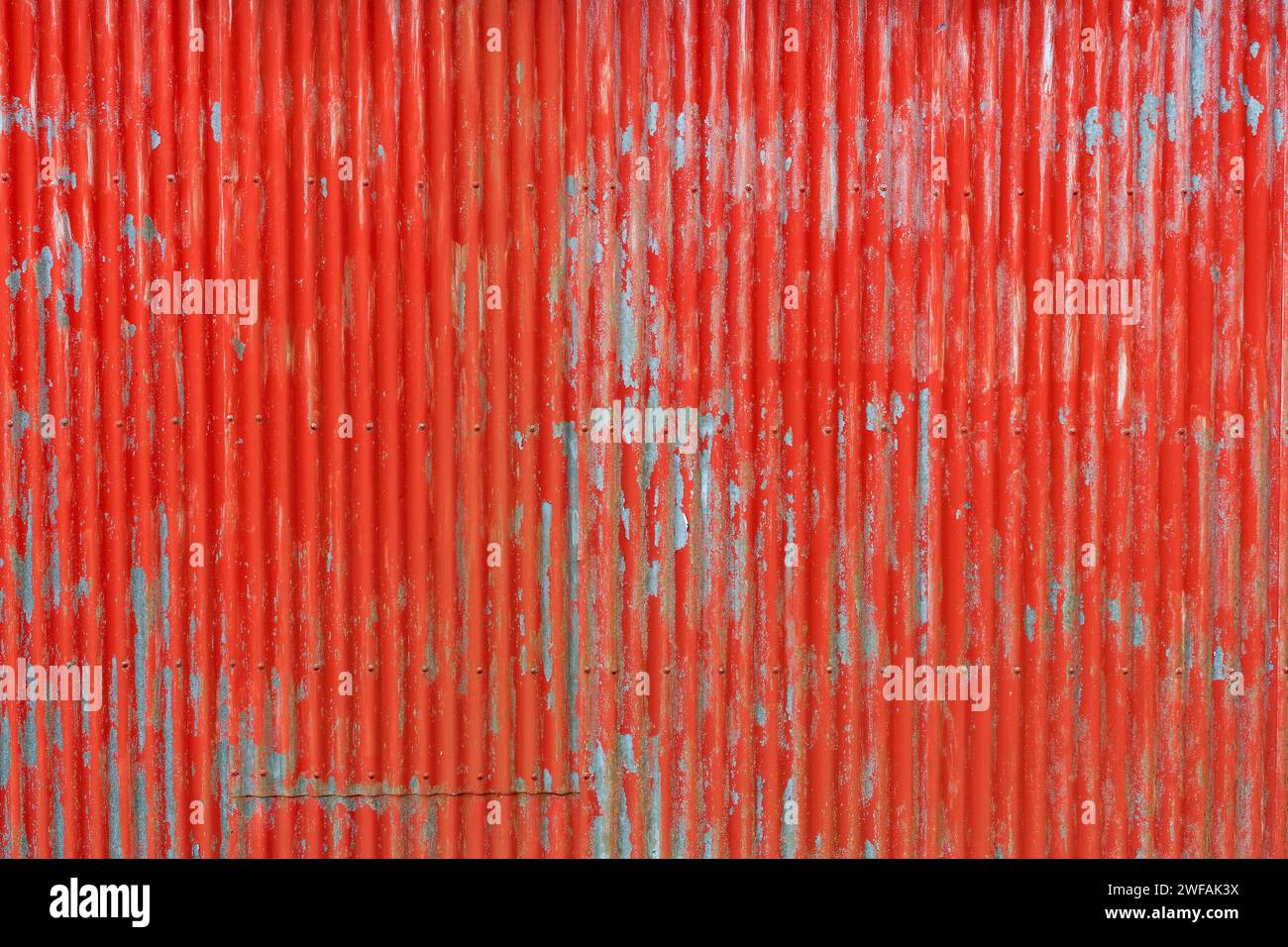 Red painted corrugated iron wall, abandoned herring factory Djupavik ...