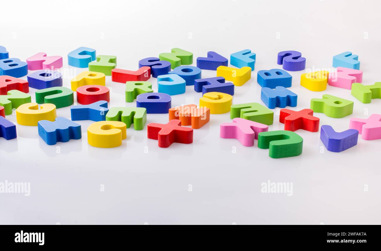 Colorful alphabet letter blocks scattered randomly on white background ...