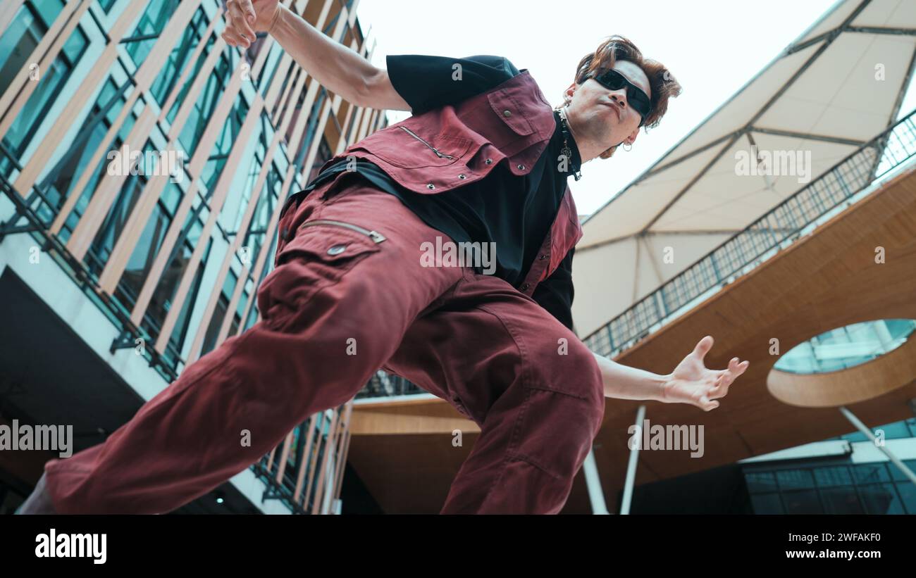 Low angle of asian attractive hipster pose at camera surround by mall ...