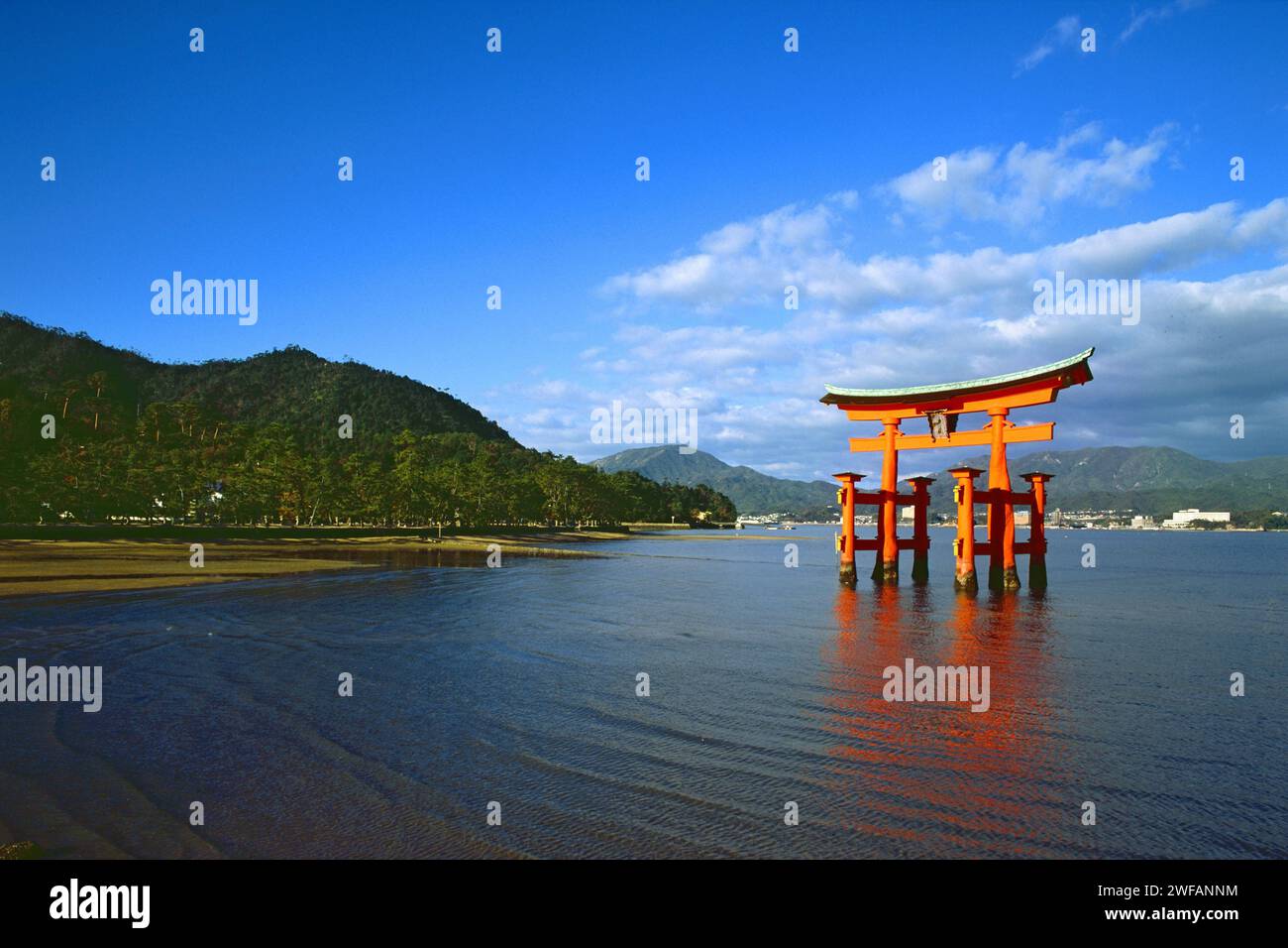The bright red Sea-gate of Miyajima temple, Japan, against a background ...