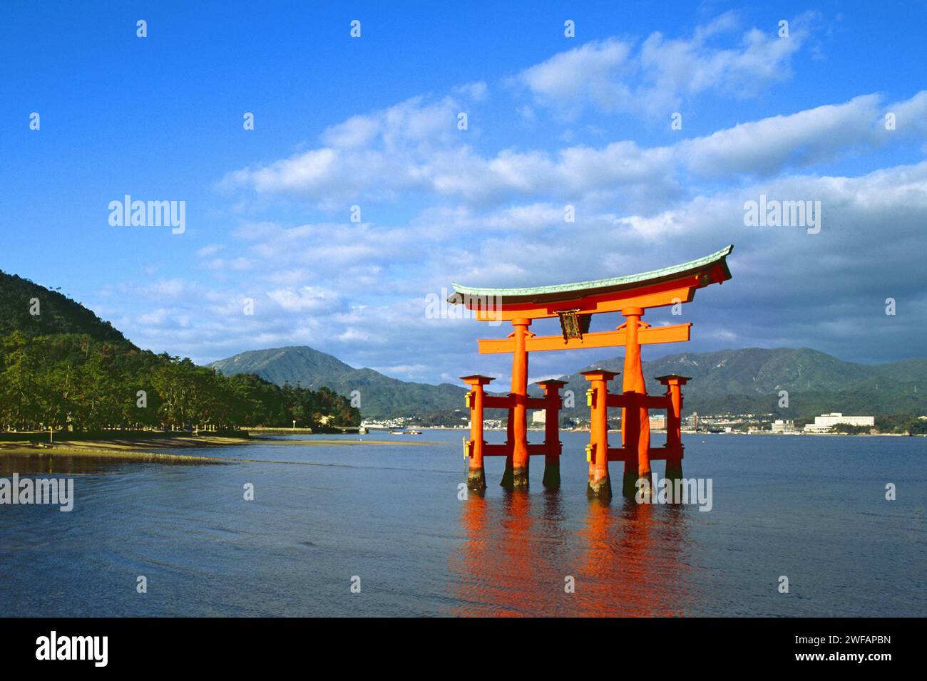 The bright red Sea-gate of Miyajima temple, Japan, against a background ...