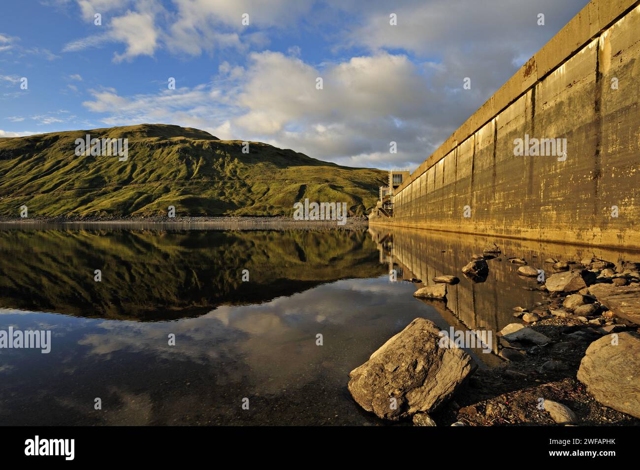Hydro-electric dam and reservoir in Glen Lyon with pebbled shore and ...