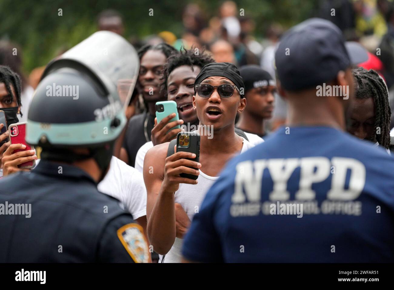 FILE - People record New York City Police Department officers as they ...