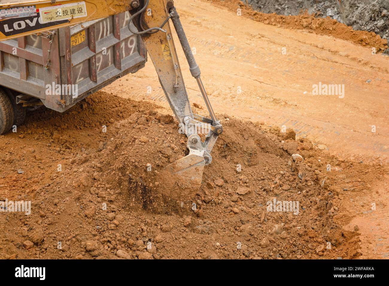 Excavator digging the land Stock Photo - Alamy