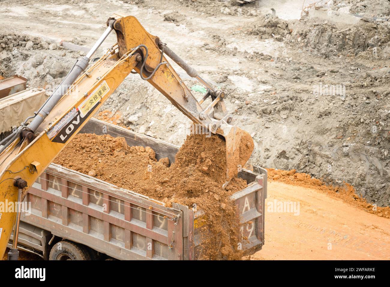 Excavator digging the land Stock Photo - Alamy