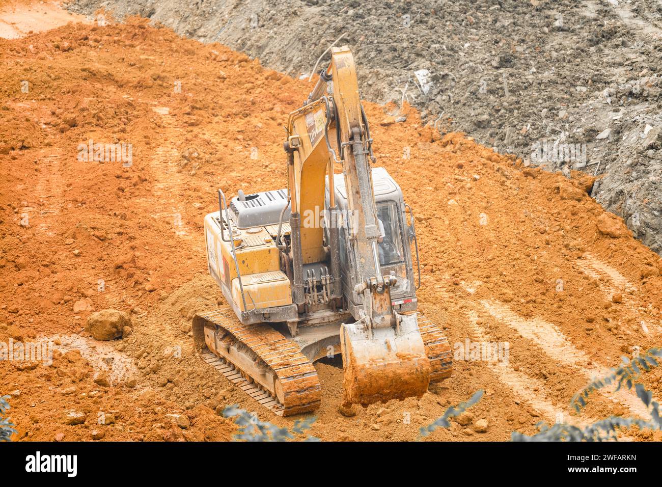 Excavator digging the land Stock Photo - Alamy