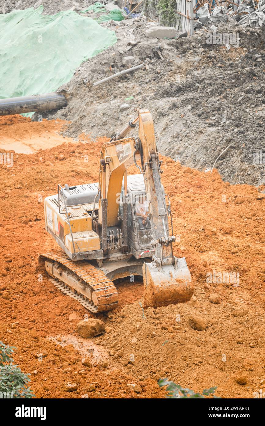 Excavator digging the land Stock Photo - Alamy