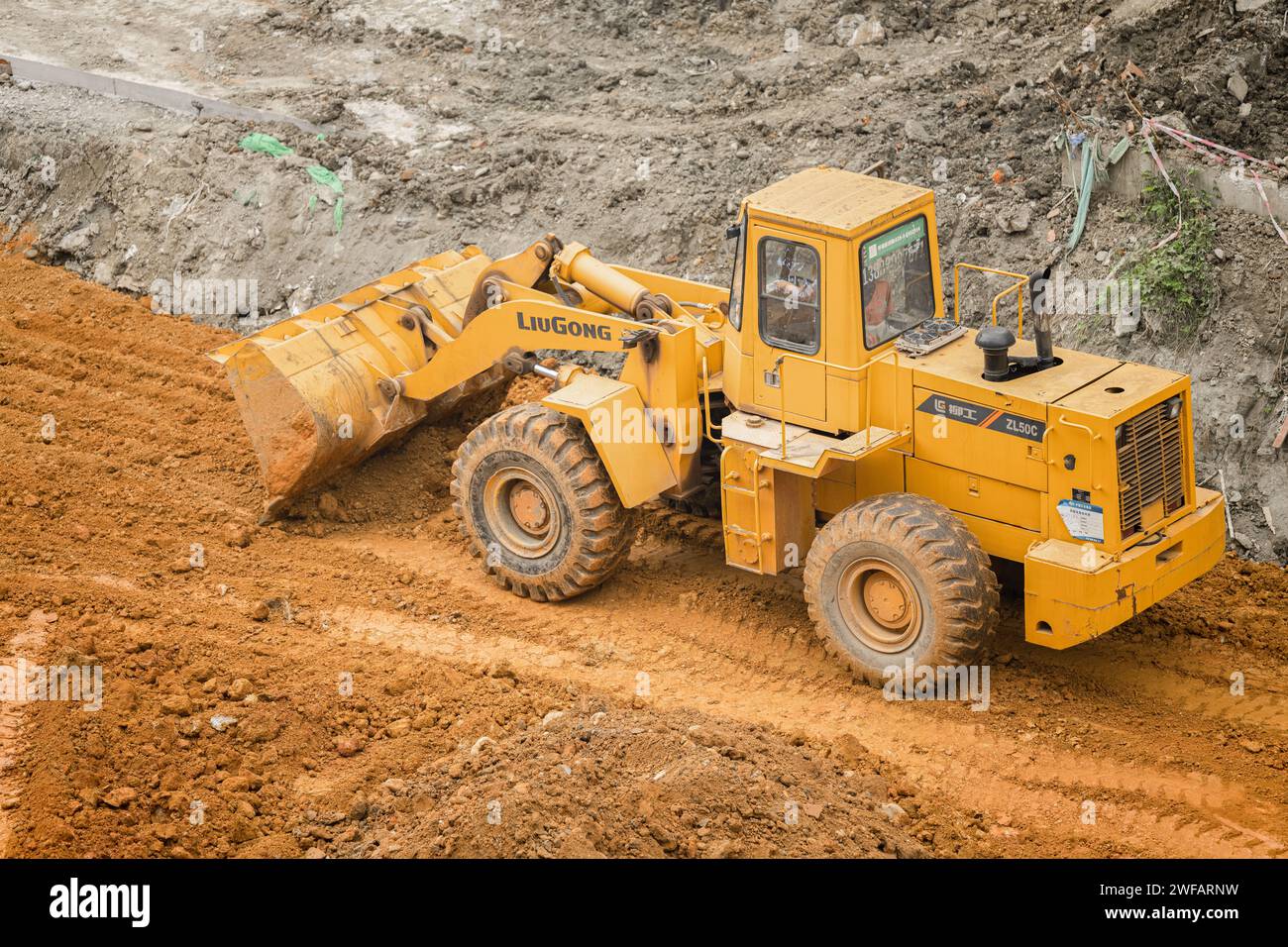 Excavator digging the land Stock Photo - Alamy