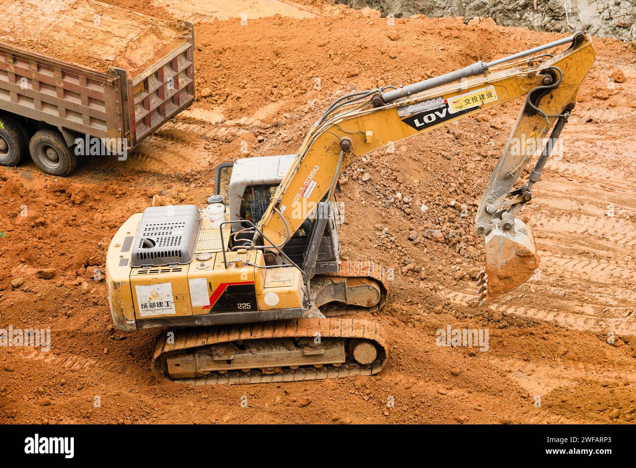 Excavator digging the land Stock Photo - Alamy