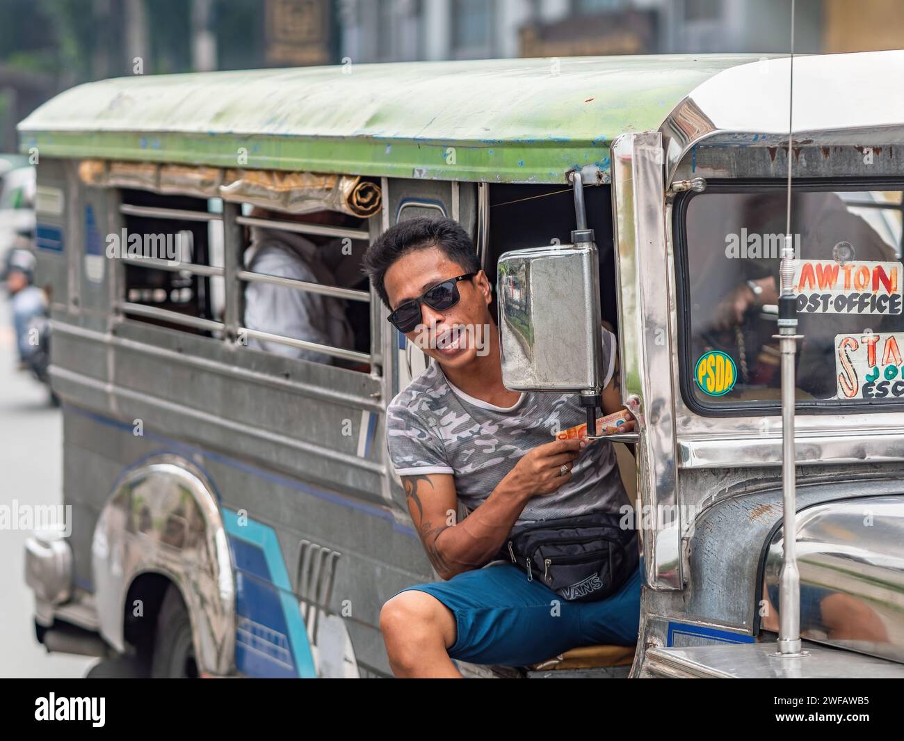 A driver of one of the popular jeepneys in Manila. Although there are ...