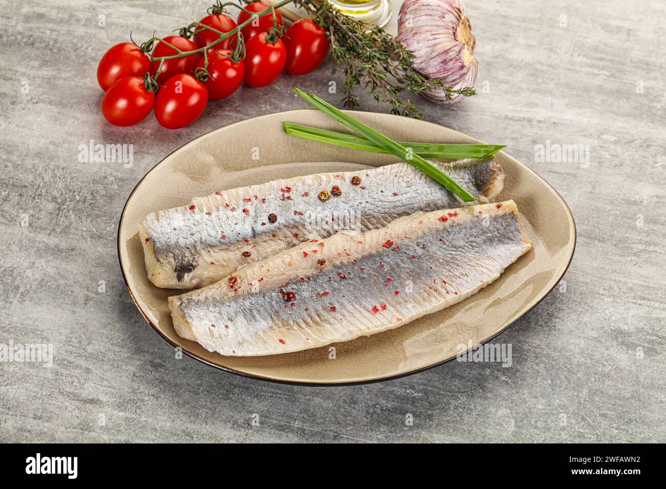 Marinated salted herring fillet with green onion Stock Photo - Alamy