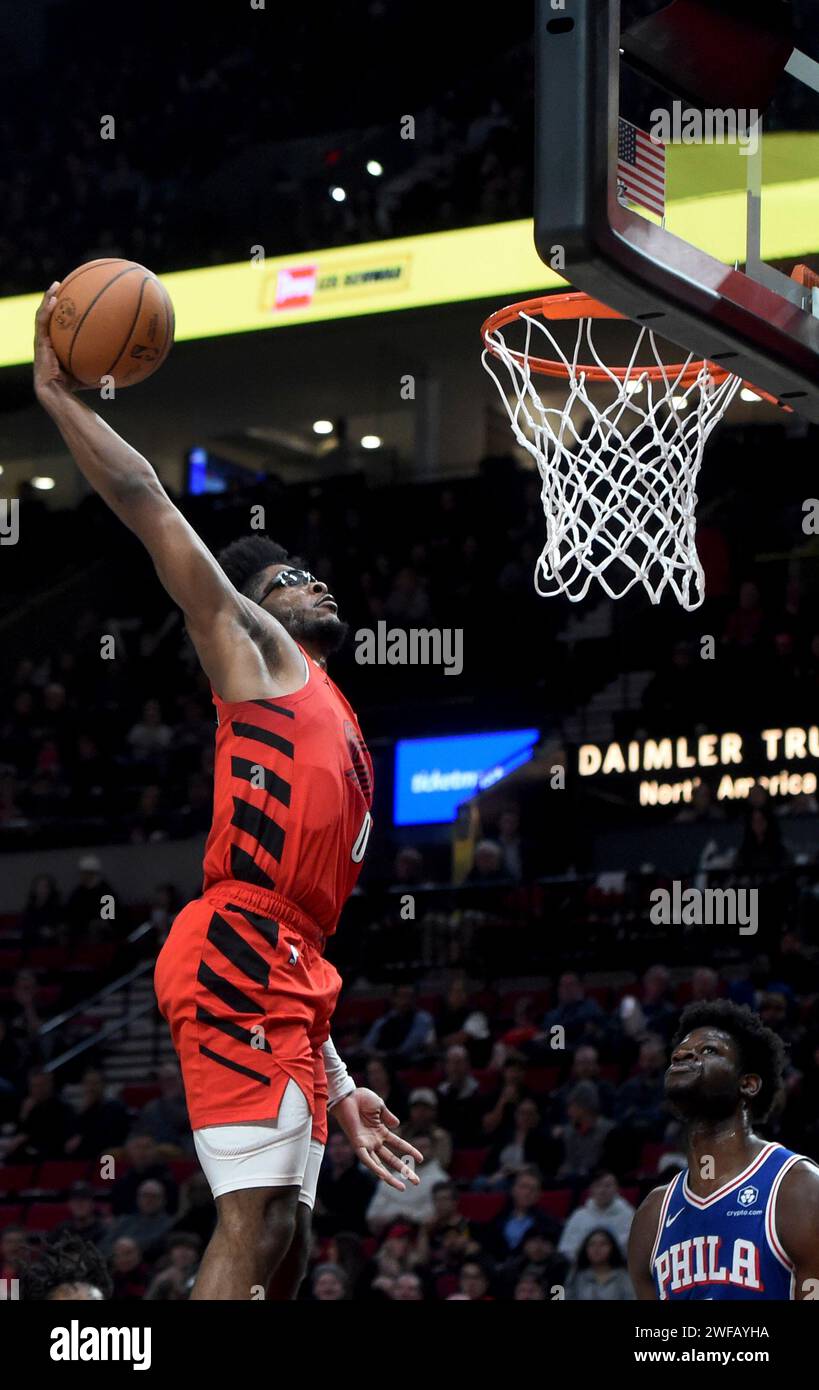 Portland Trail Blazers guard Scoot Henderson, left, dunks the ball on ...