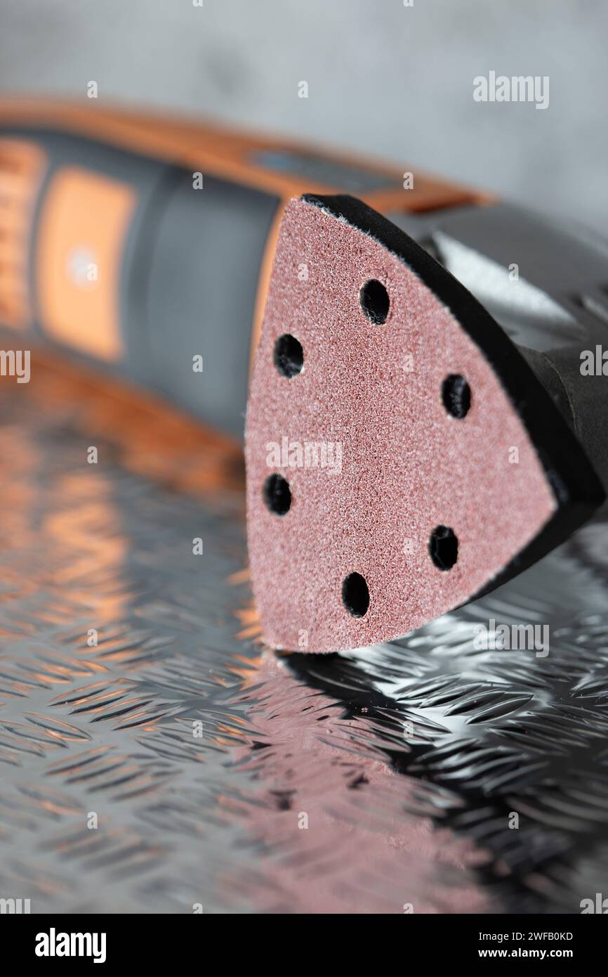 Sanding attachment, with sandpaper, on an electric sander and cutting ...