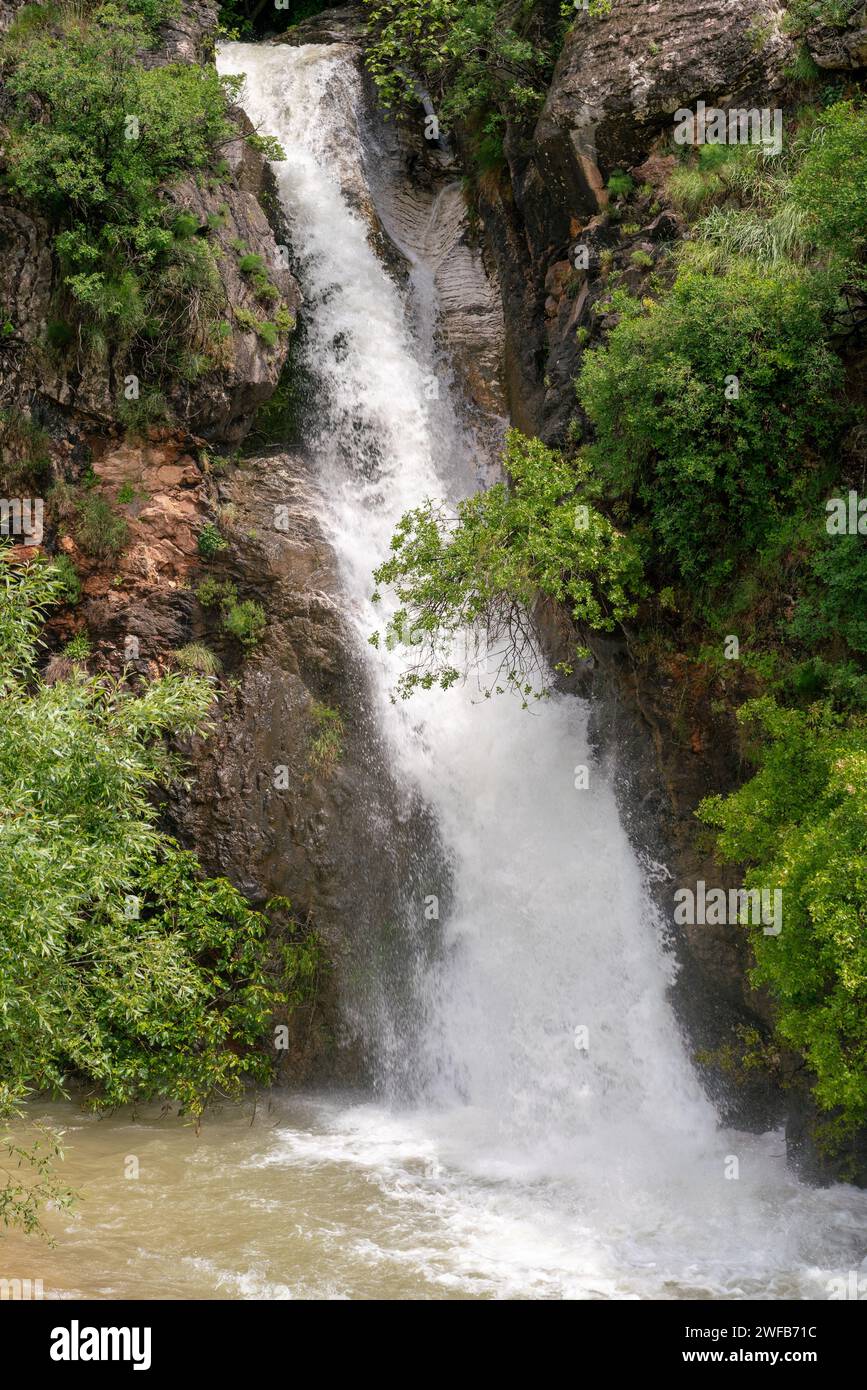 Water stream of mountain waterfall flowing between picturesque rocks ...