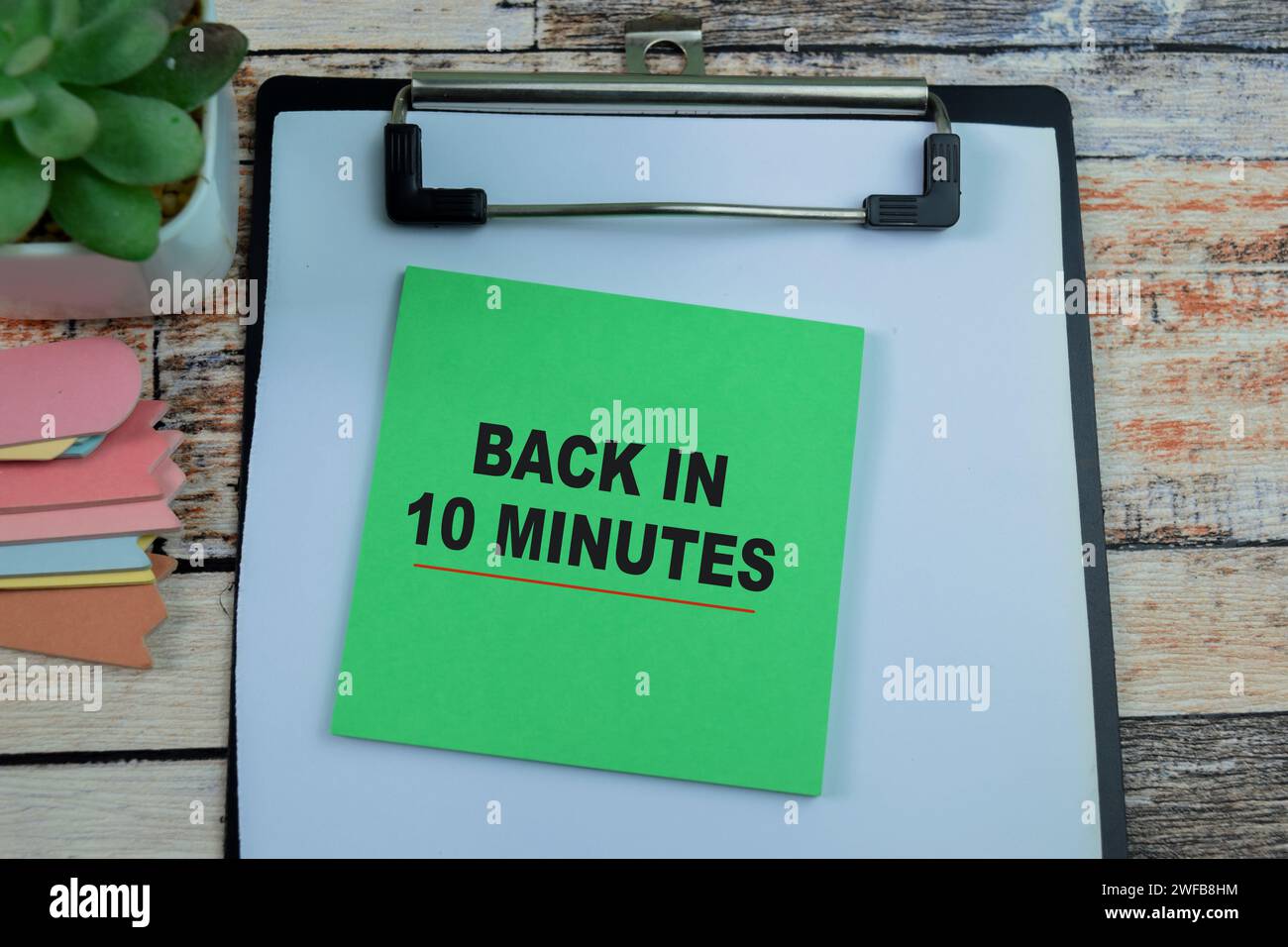 Concept of Back In 10 Minutes write on sticky notes isolated on Wooden ...