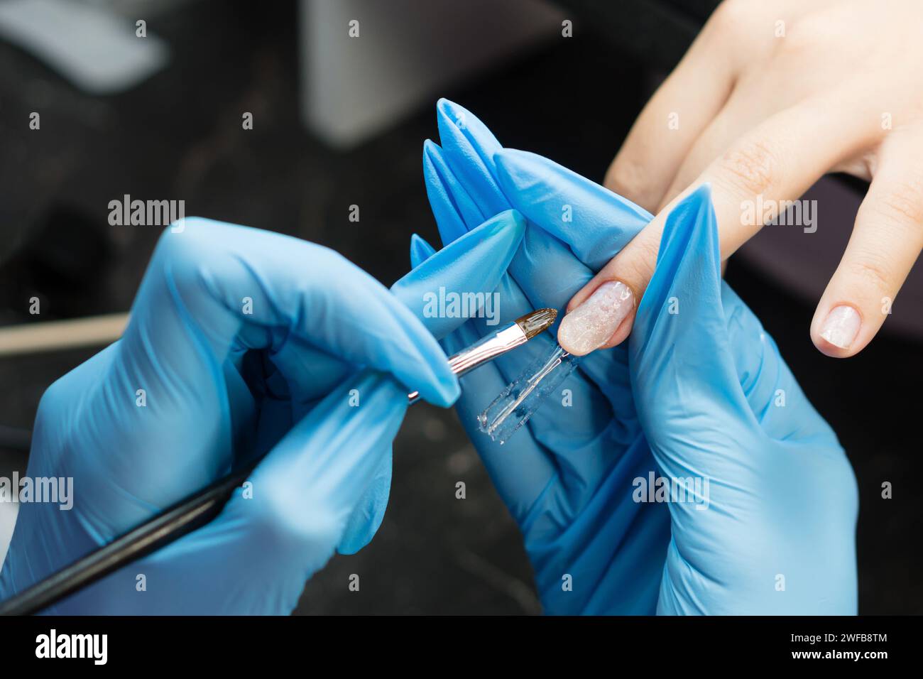 Application of nail polish using a precise brush in a salon Stock Photo ...