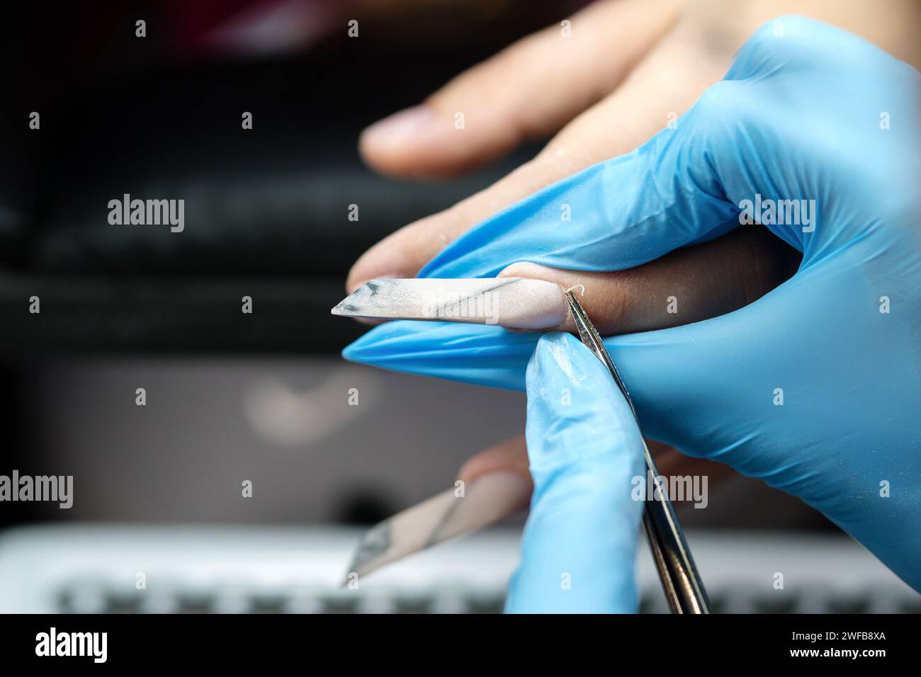 A detailed view of the EDGE nail shaping process, capturing the precise ...