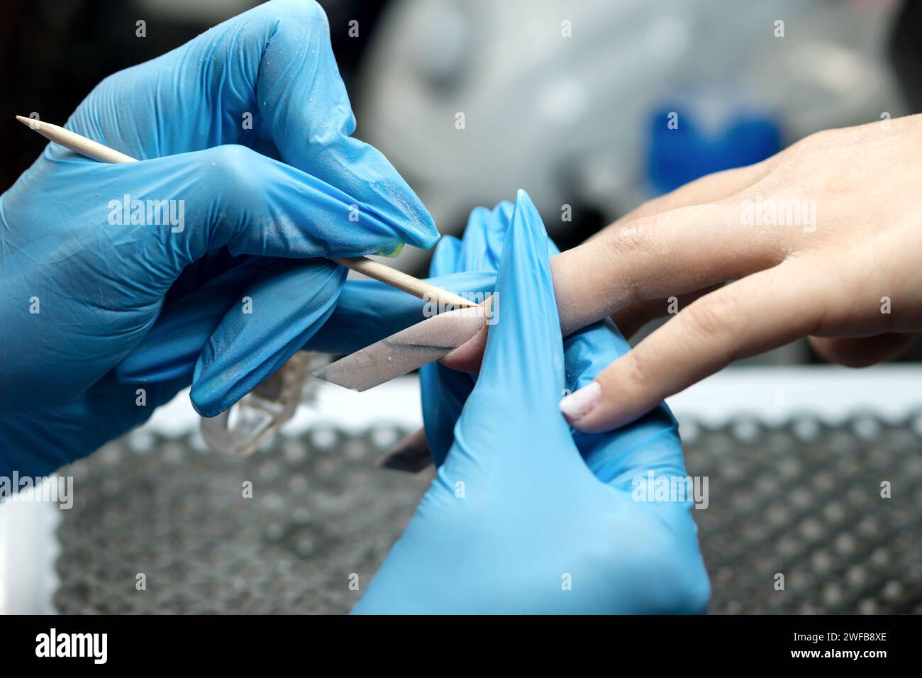 A detailed view of the EDGE nail shaping process, capturing the precise ...