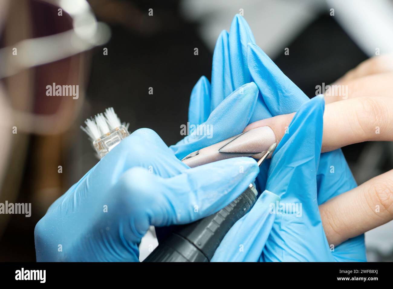 Detailed view of the EDGE nail shaping process, capturing the precise ...