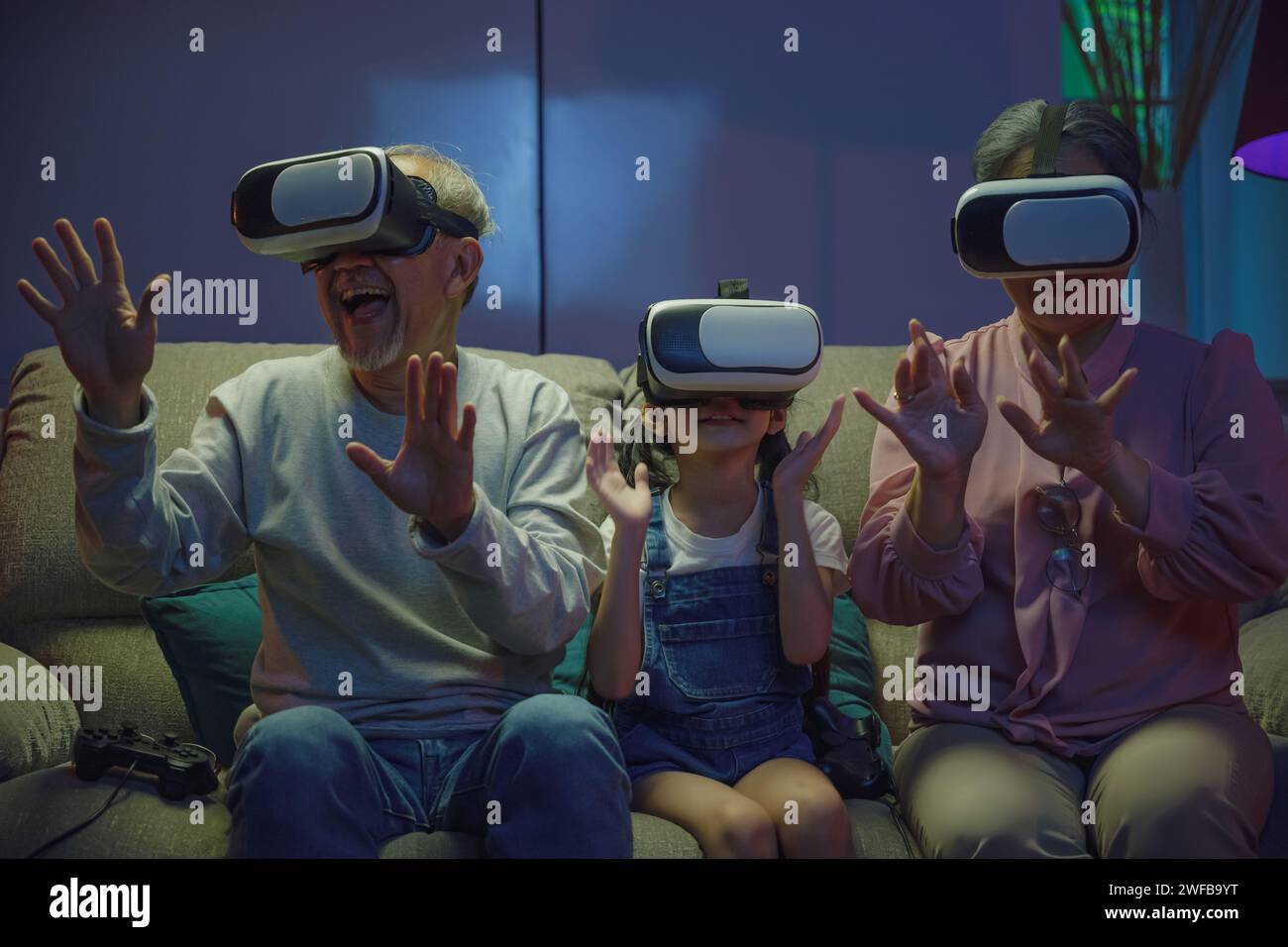 Asian elderly with child play VR video game Stock Photo - Alamy