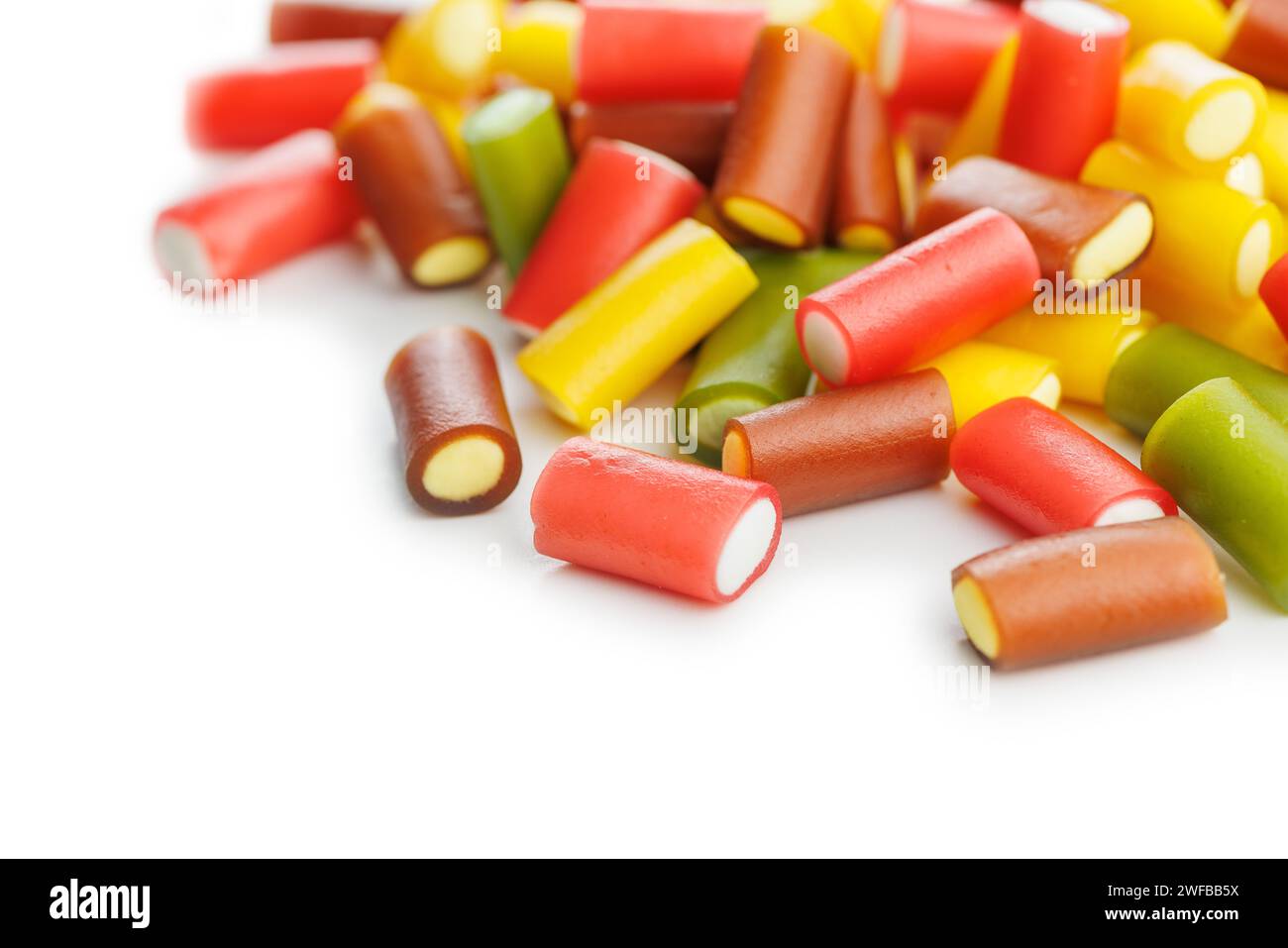 Sweet colorful chewy candy sticks isolated on the white background ...