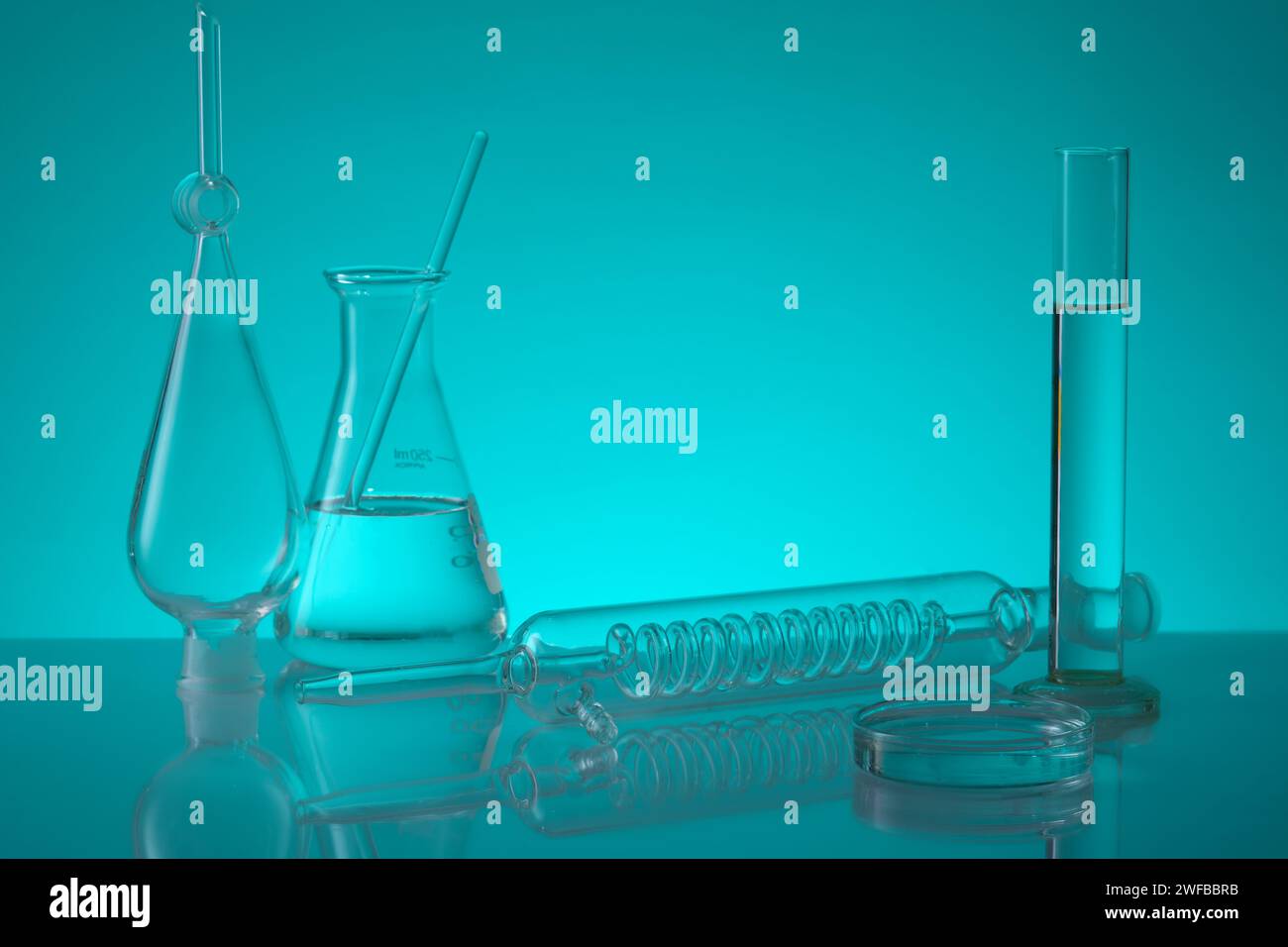 Over a blue background, erlenmeyer flask, a tube with spiral pipe ...