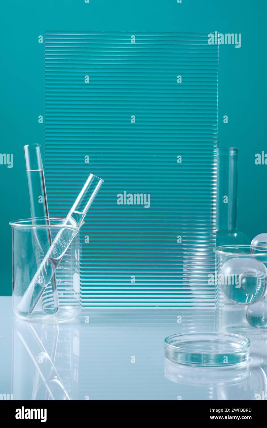 Ribbed acrylic sheets, a beaker containing two test tubes of liquid ...