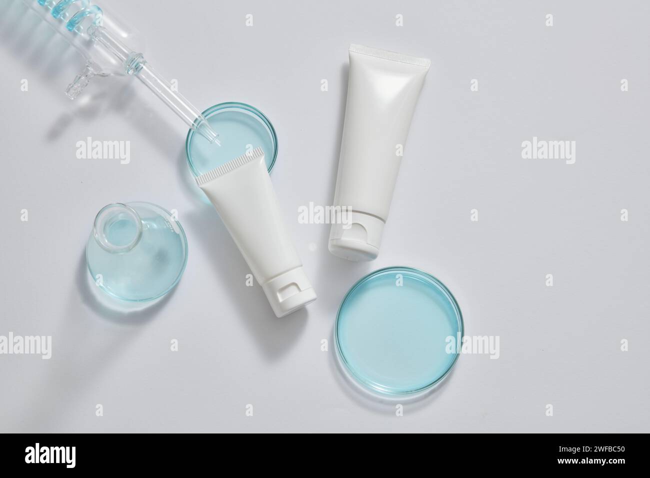 Two white tubes with different sizes decorated with petri dishes ...