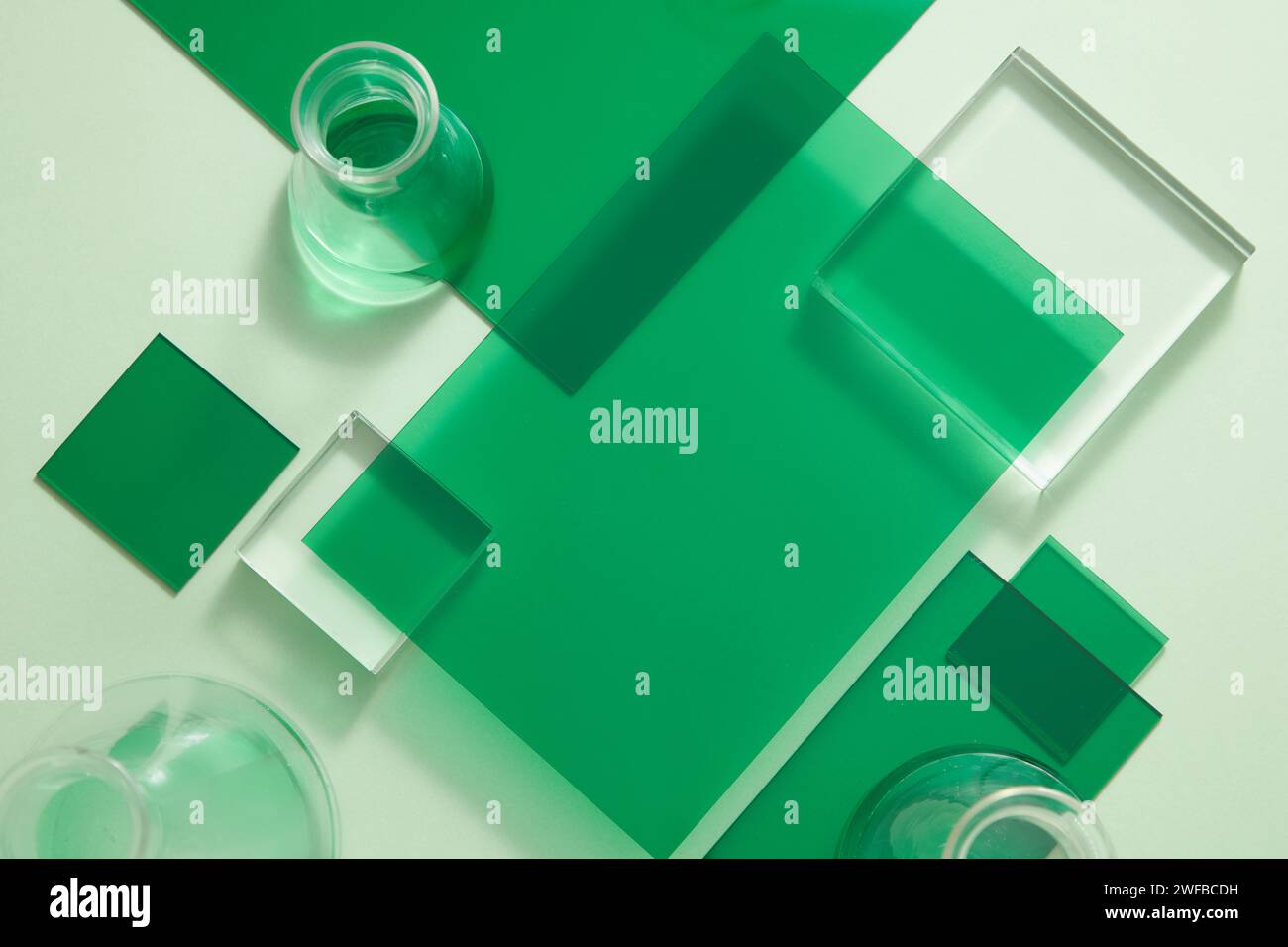 Many green plastic board are displayed with some erlenmeyer flask ...