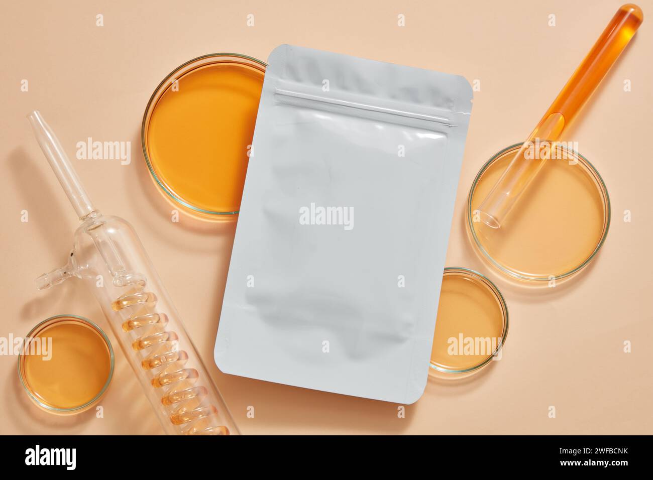 A mask sheet with unlabeled packaging decorated with petri dishes and ...