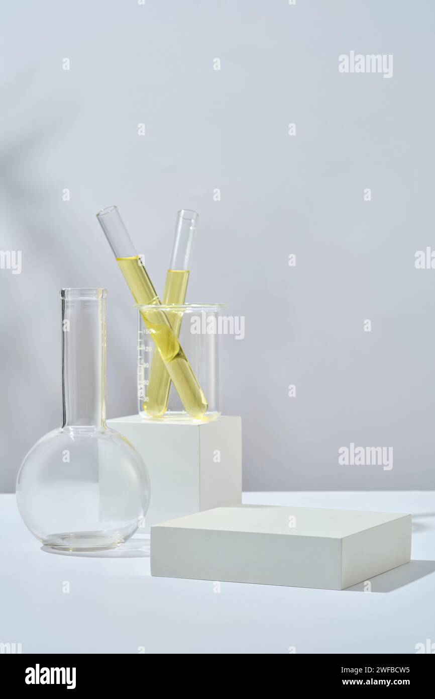 Test tube containing yellow liquid inside a beaker placed on cube ...