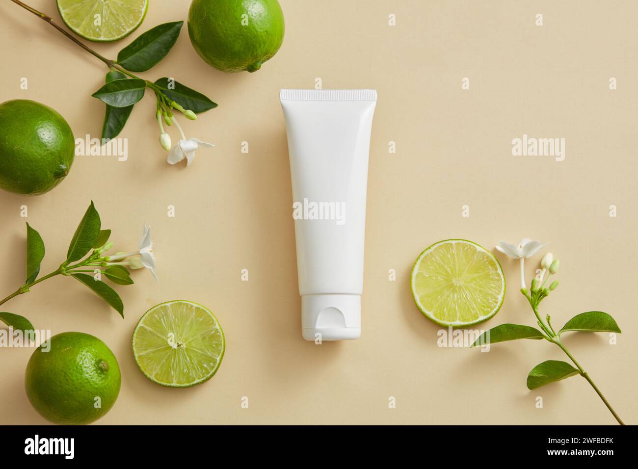 A white tube without label put in the middle with flower branches and ...