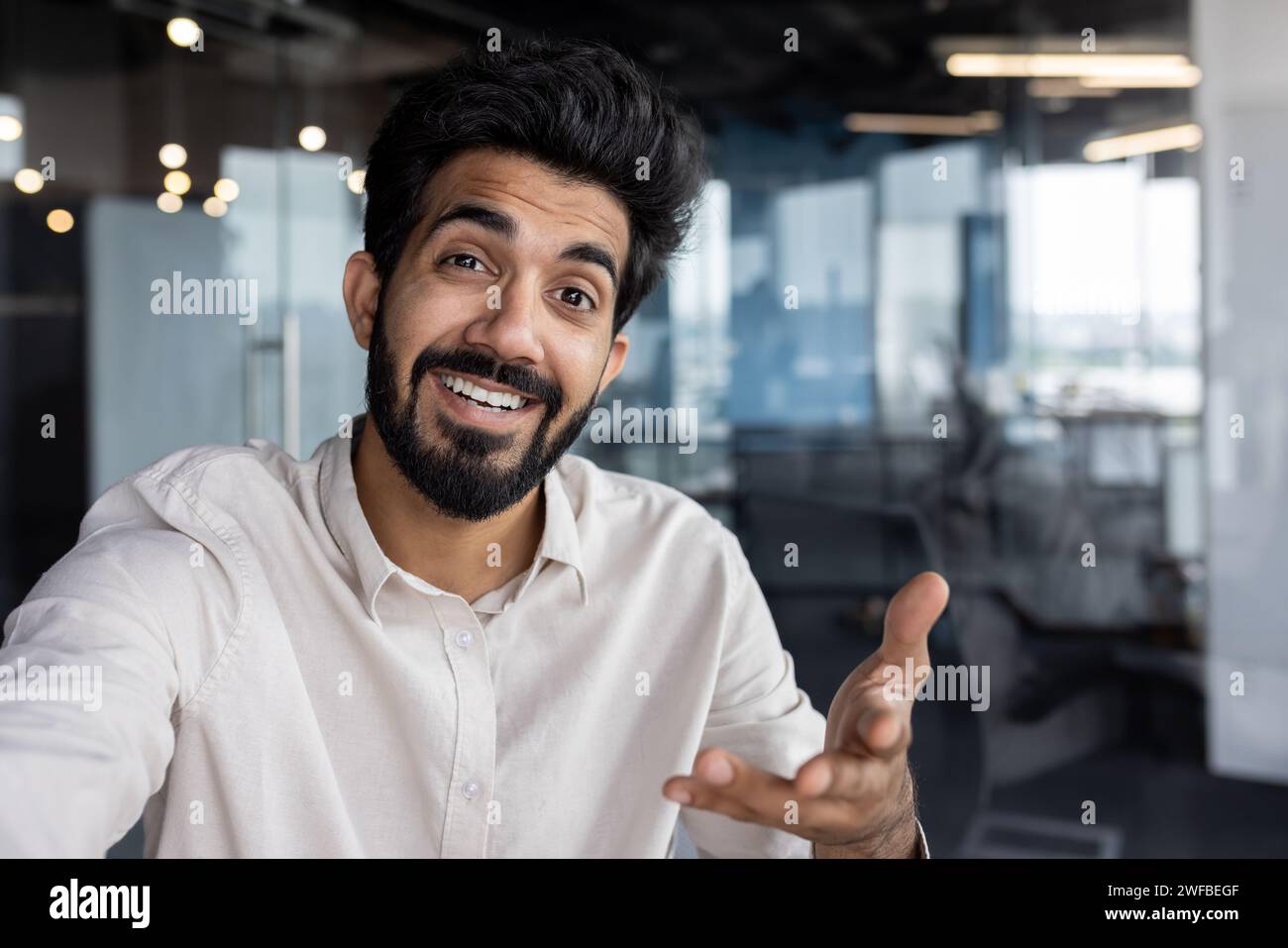 Close-up photo of a young Indian man talking in the office on a camera ...