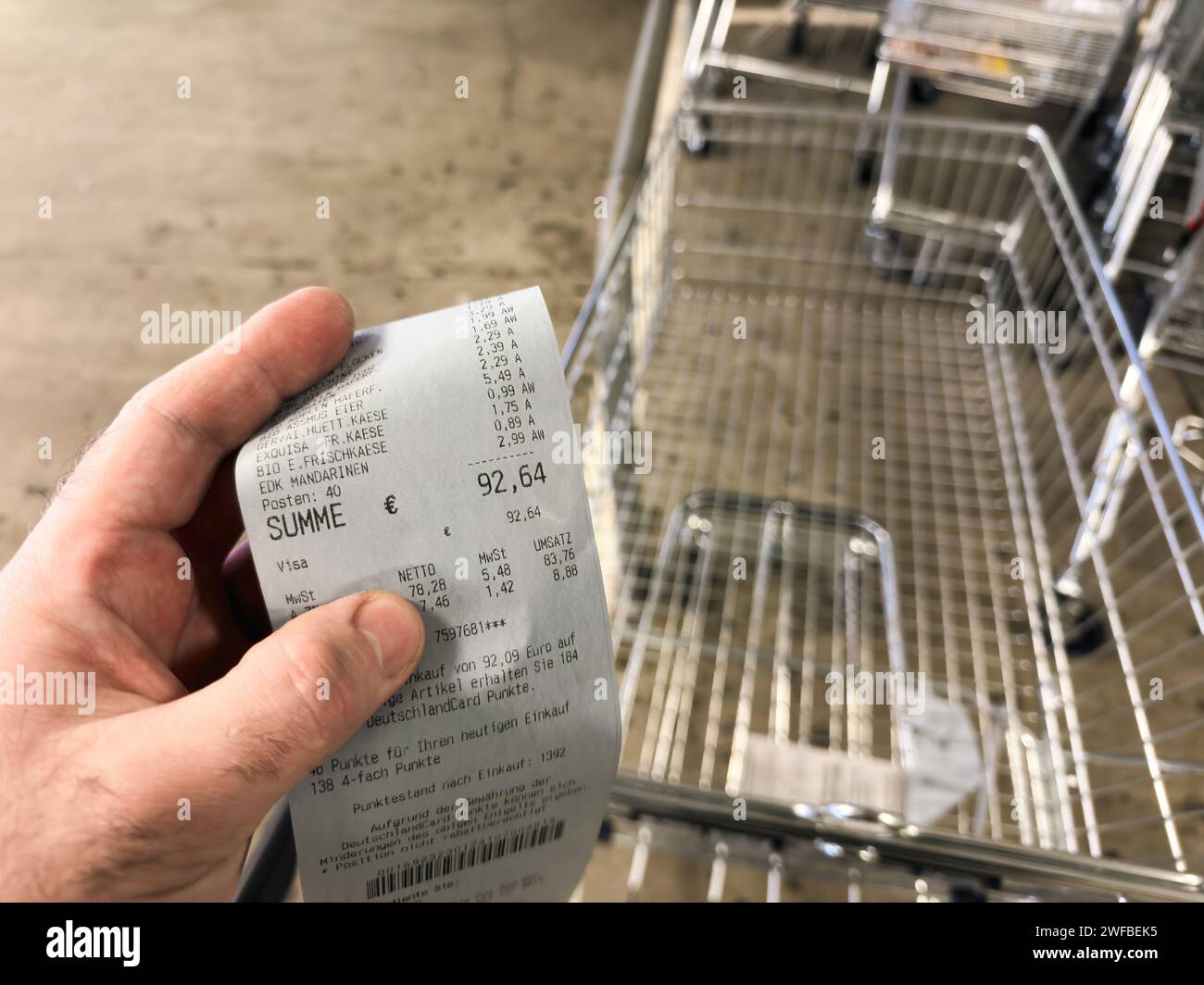 Berlin, Germany - Jan 23, 2024:POV of a male hand holding a paper ...