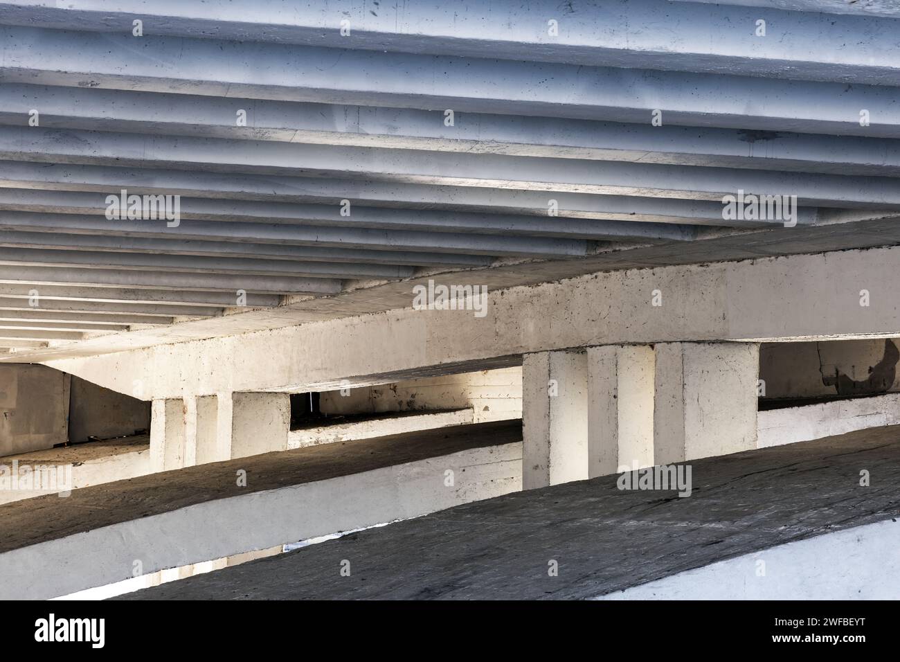 Concrete details of an overhead bridge, girders and pillars. Abstract ...