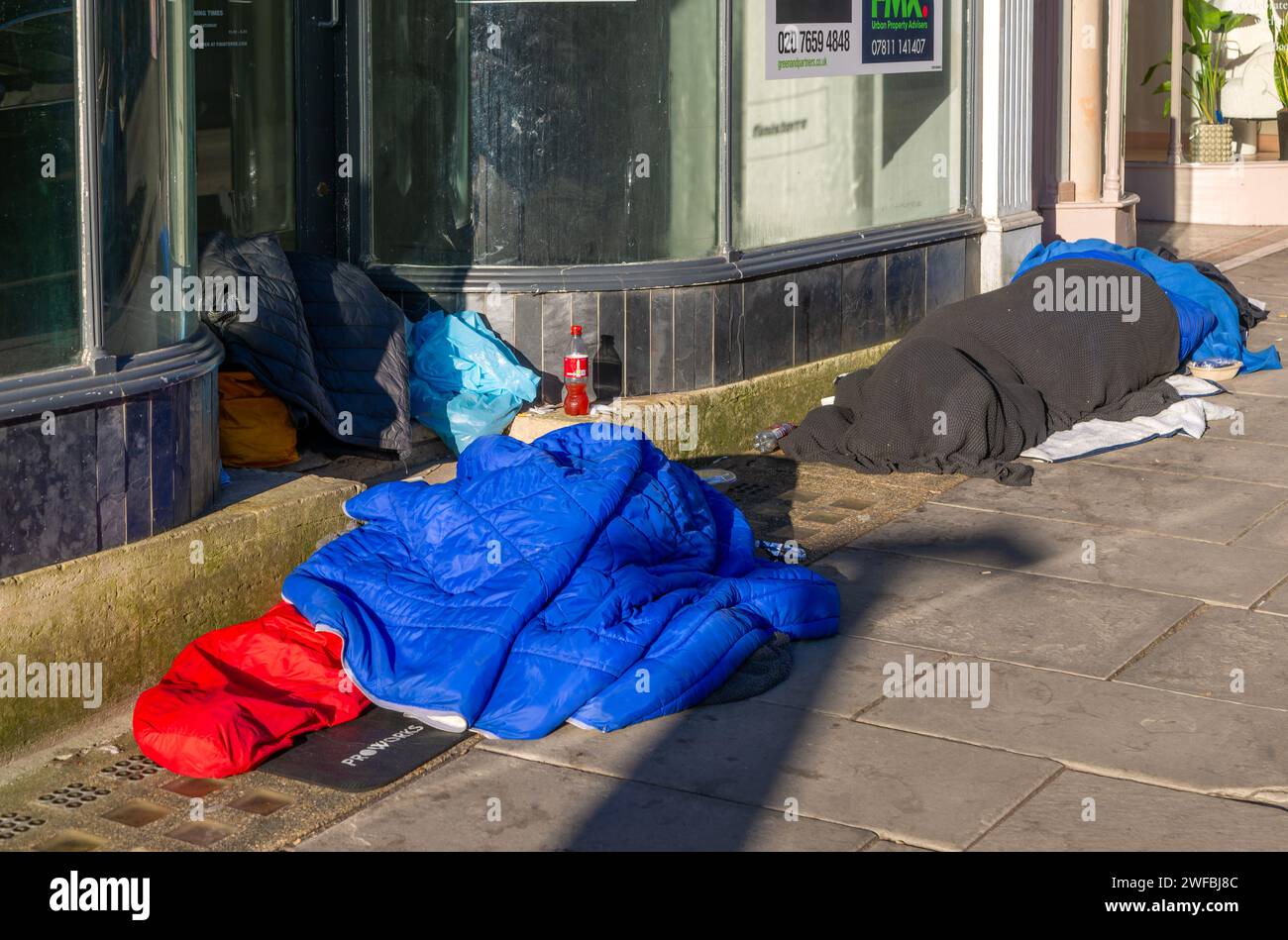 Homeless people sleeping on the street in city centre, Milsom Street ...