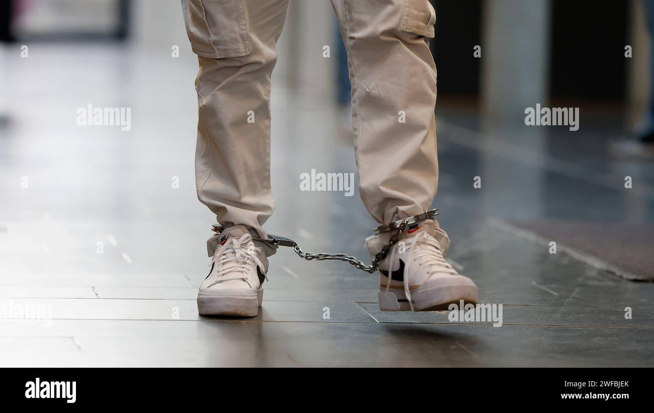 30 January 2024, Bavaria, Würzburg: The defendant is brought to the ...